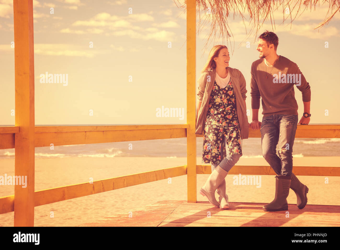 Happy couple enyojing time together on beach during autumn day Stock ...