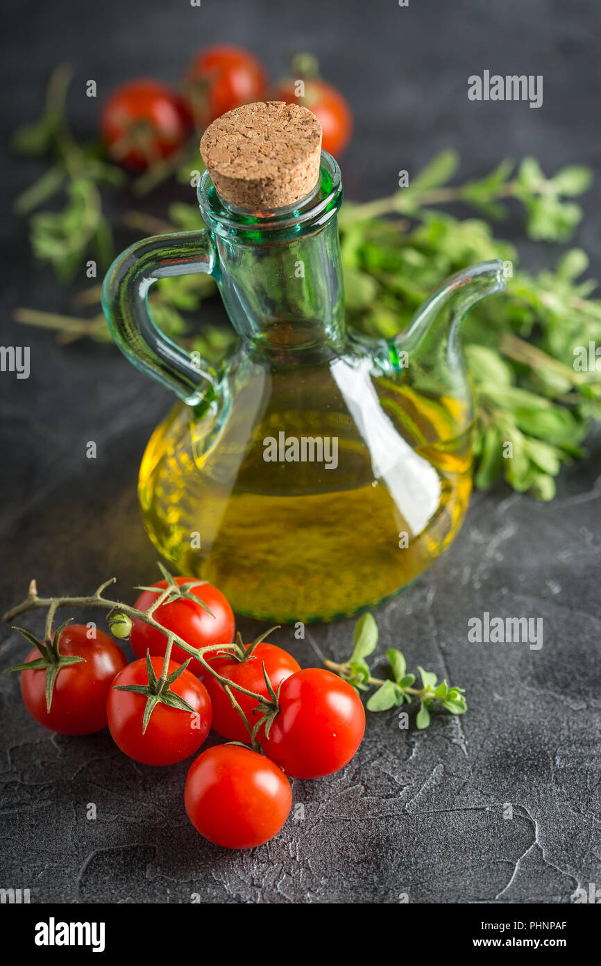 Bottle with vegetable oil and cherry tomatoes Stock Photo - Alamy
