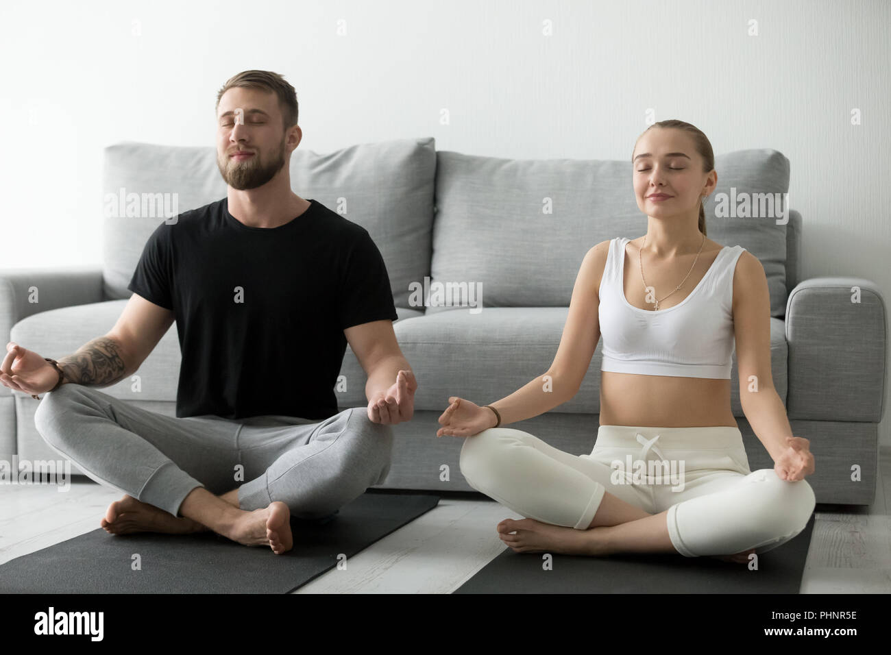 Couple sitting in lotus position hi-res stock photography and images ...