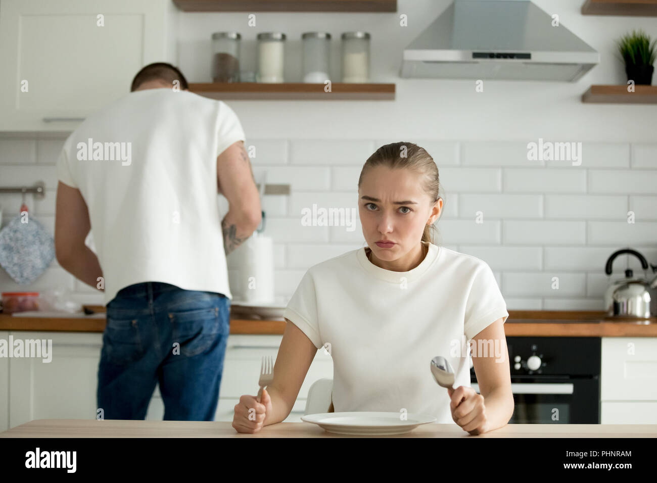 Hungry wife look dissatisfied waiting for husband cooking Stock Photo ...