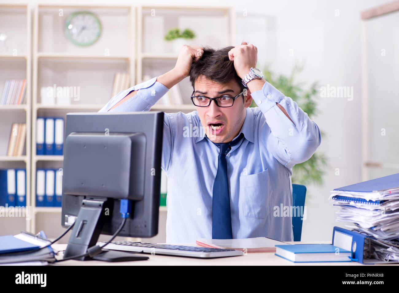 Angry businessman frustrated with too much work Stock Photo - Alamy
