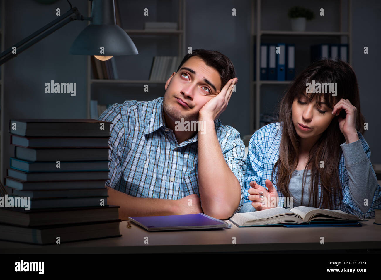 Two students studying late at night Stock Photo - Alamy
