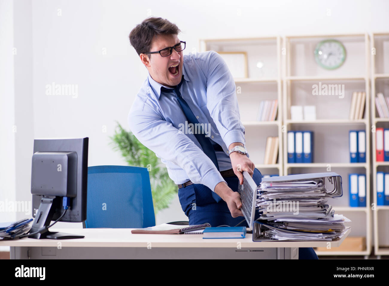 Angry businessman frustrated with too much work Stock Photo - Alamy