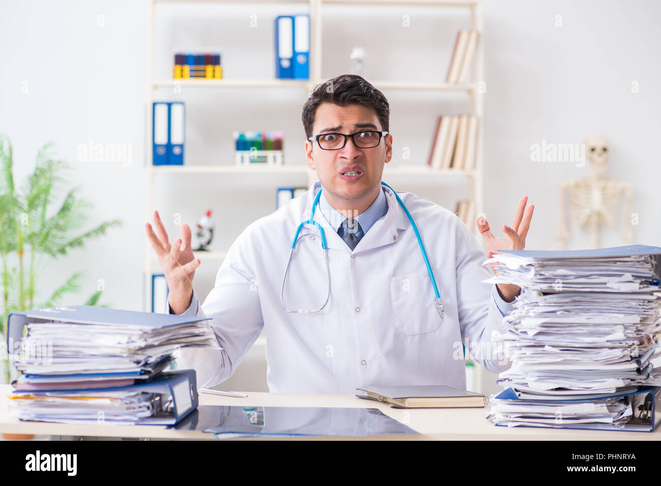 Busy doctor with too much work in hospital Stock Photo - Alamy