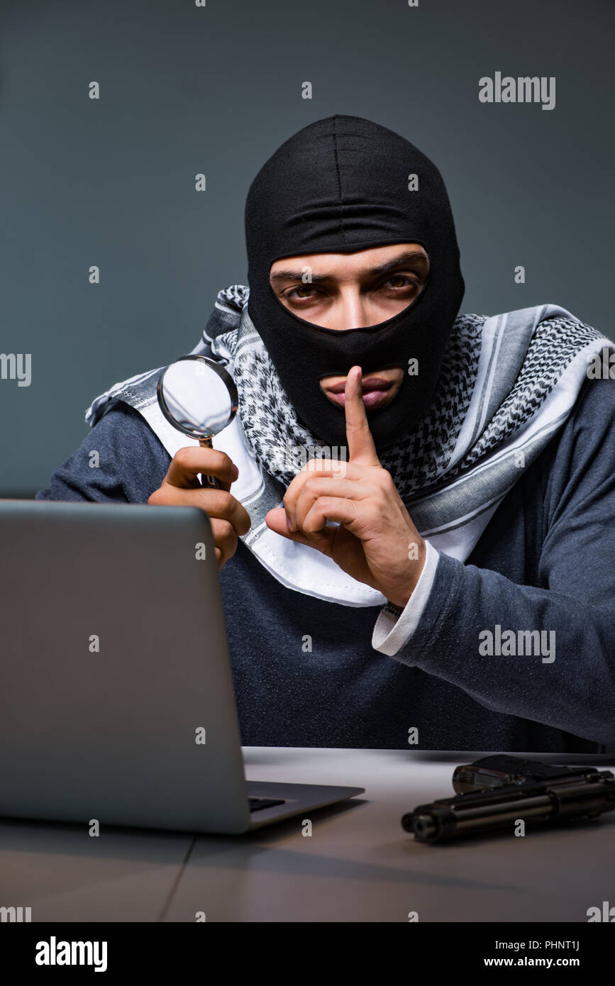 Hacker wearing balaclava mask hacking computer Stock Photo - Alamy