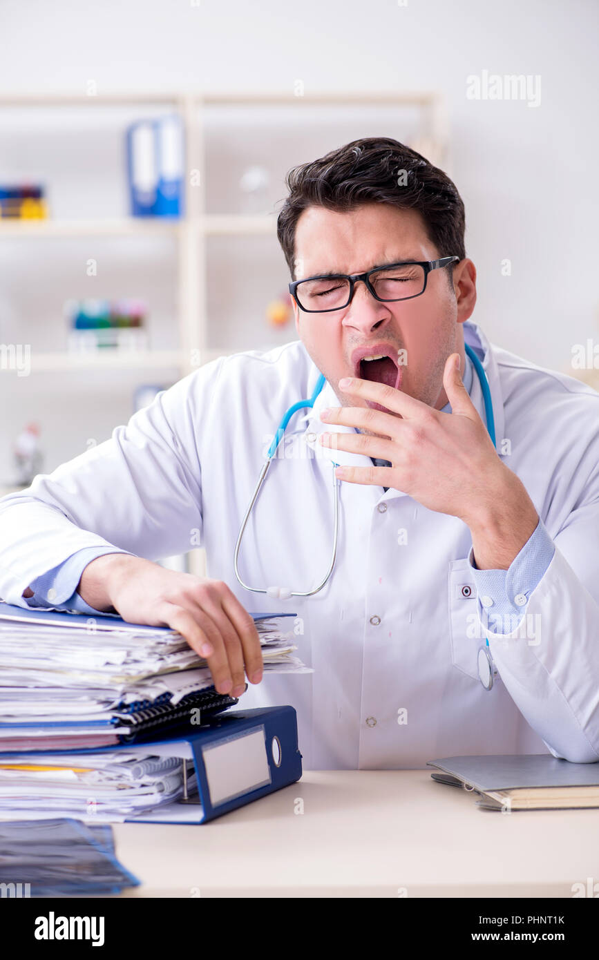 Busy doctor with too much work in hospital Stock Photo - Alamy