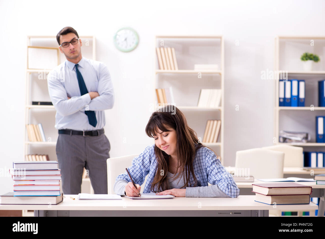 Male lecturer giving lecture to female student Stock Photo - Alamy