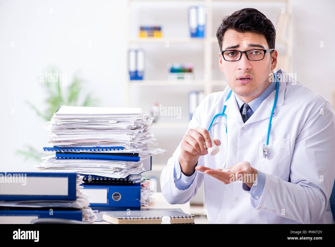 Busy doctor with too much work in hospital Stock Photo - Alamy