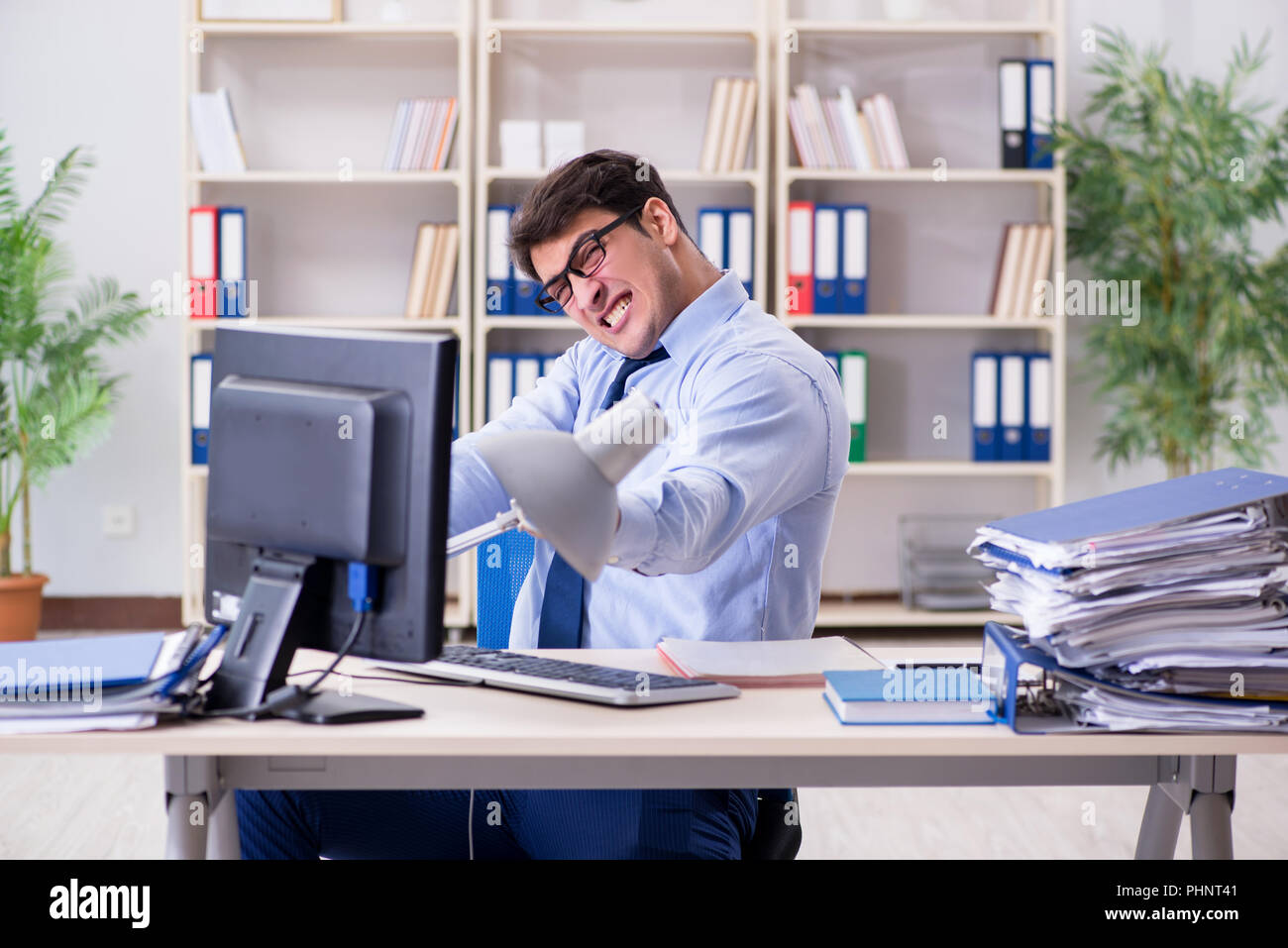 Angry businessman frustrated with too much work Stock Photo - Alamy