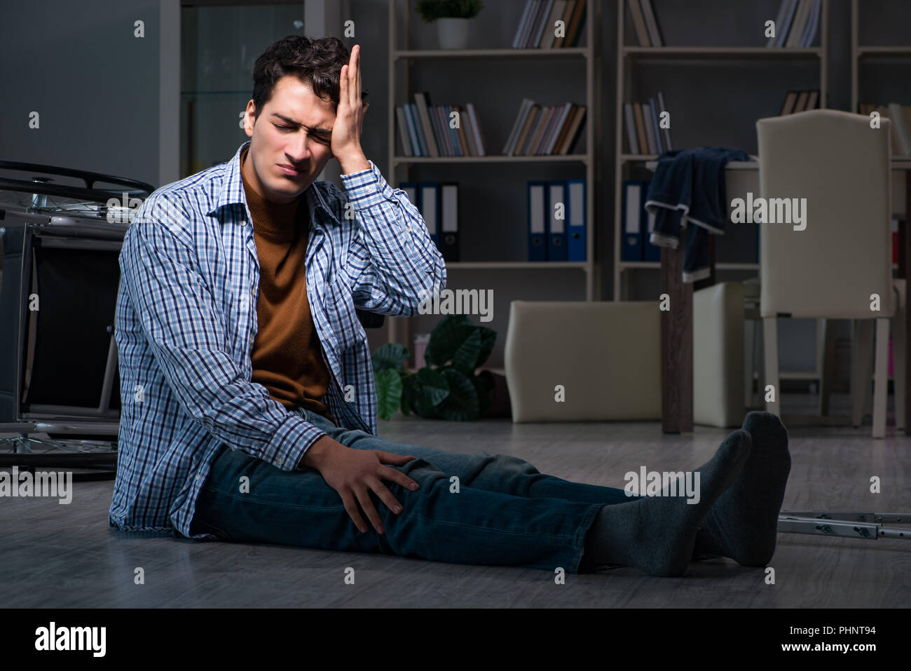 Man fell off wheelchair sitting on the floor Stock Photo - Alamy