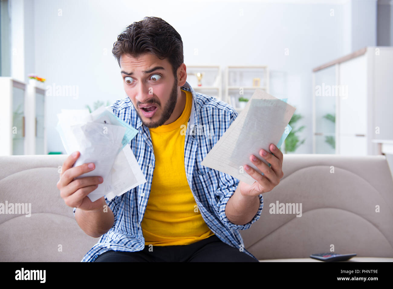 Man angry at bills he needs to pay Stock Photo - Alamy