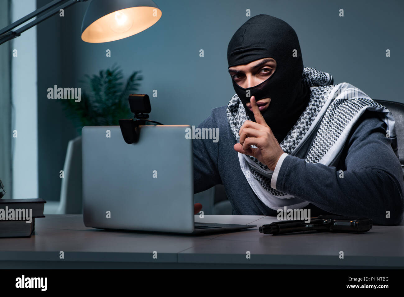 Hacker wearing balaclava mask hacking computer Stock Photo - Alamy