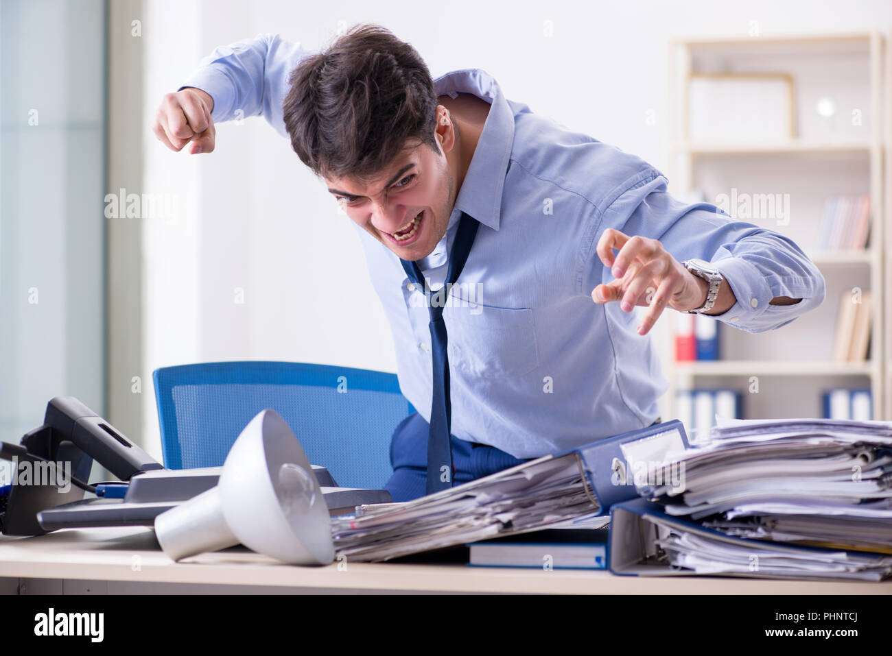 Angry businessman frustrated with too much work Stock Photo - Alamy