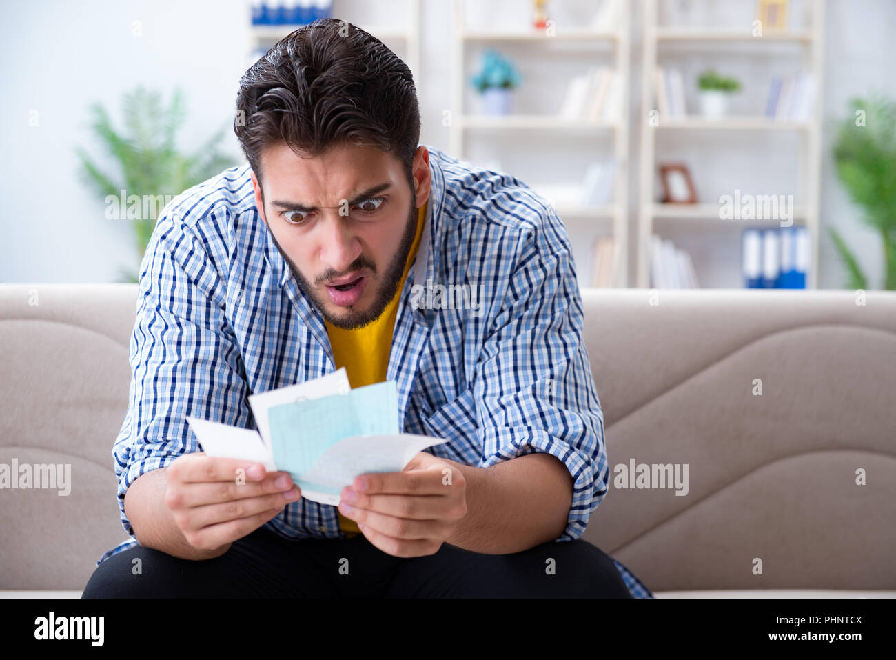 Man angry at bills he needs to pay Stock Photo - Alamy