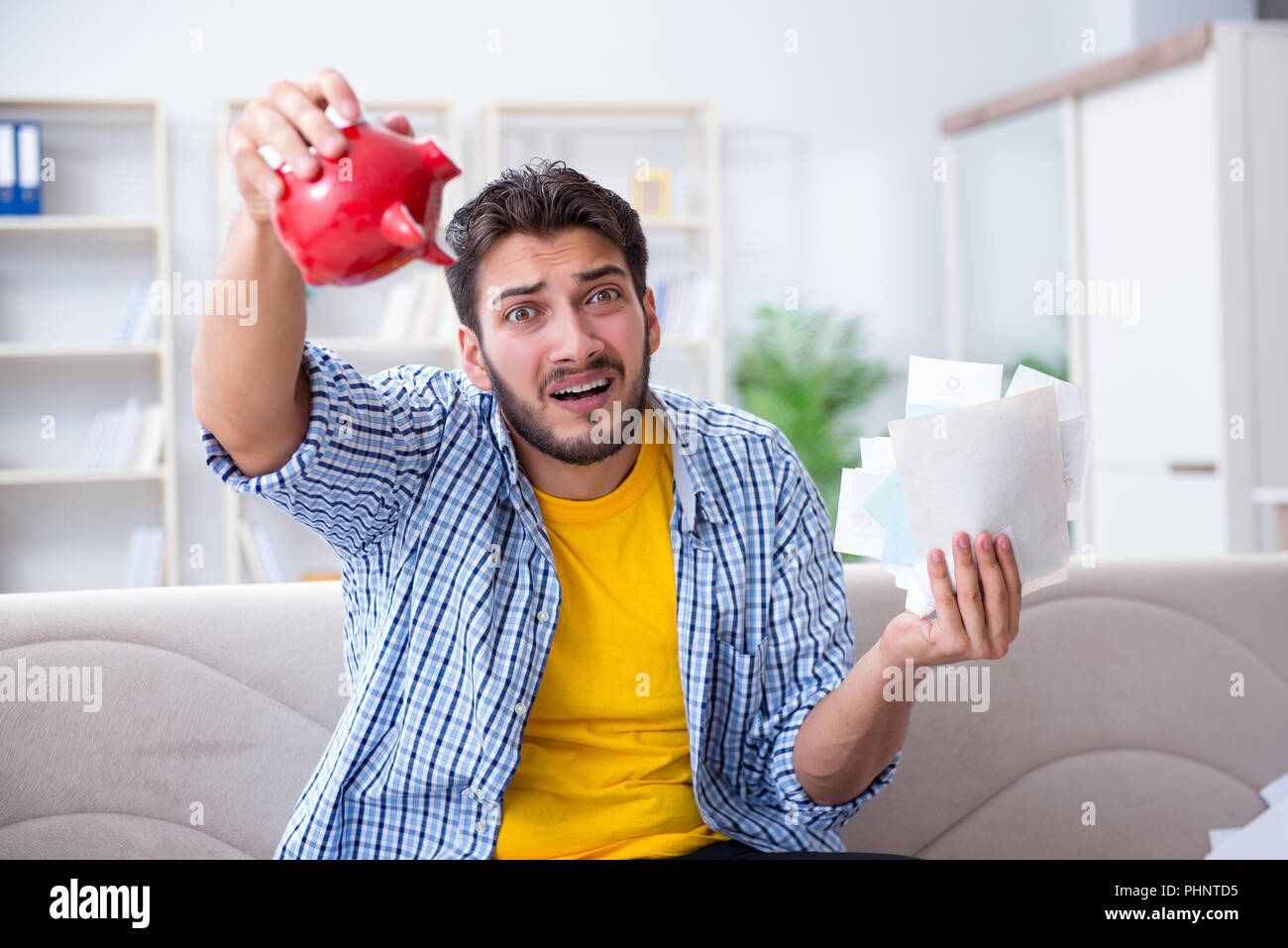 Man angry at bills he needs to pay Stock Photo - Alamy