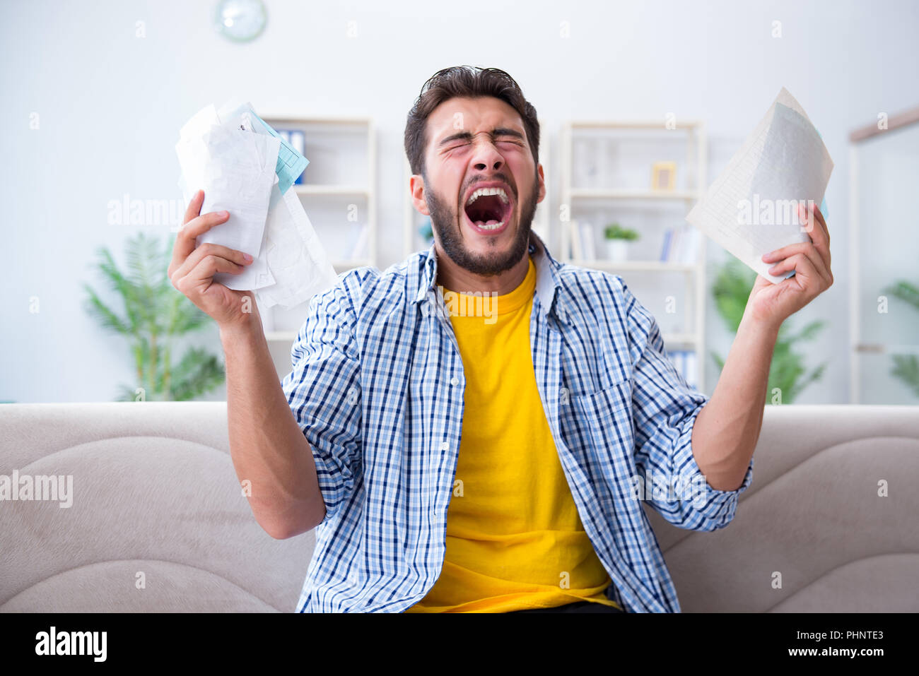 Man angry at bills he needs to pay Stock Photo - Alamy