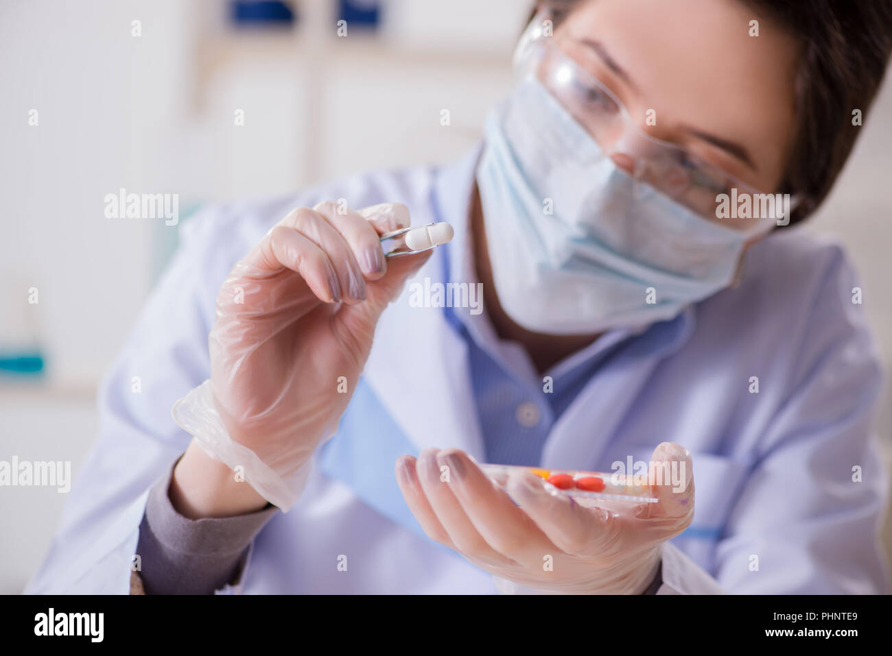 Lab assistant in drug synthesis concept Stock Photo - Alamy