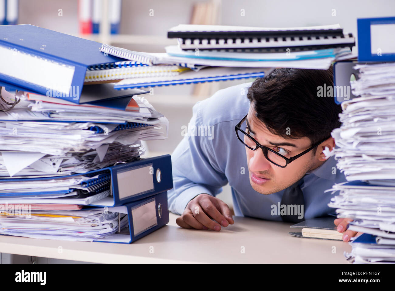 Extremely busy businessman working in office Stock Photo - Alamy