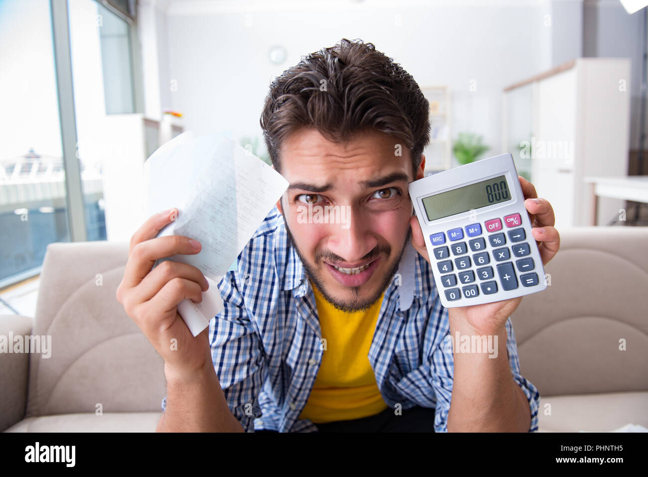Man angry at bills he needs to pay Stock Photo - Alamy