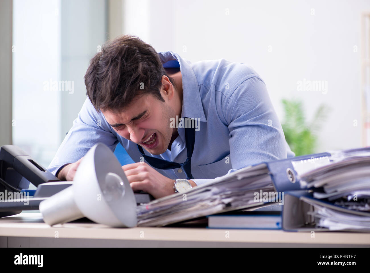 Angry businessman frustrated with too much work Stock Photo - Alamy