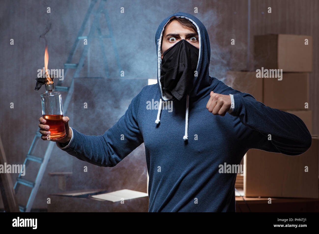 Rebel with molotov cocktail in dark room Stock Photo - Alamy