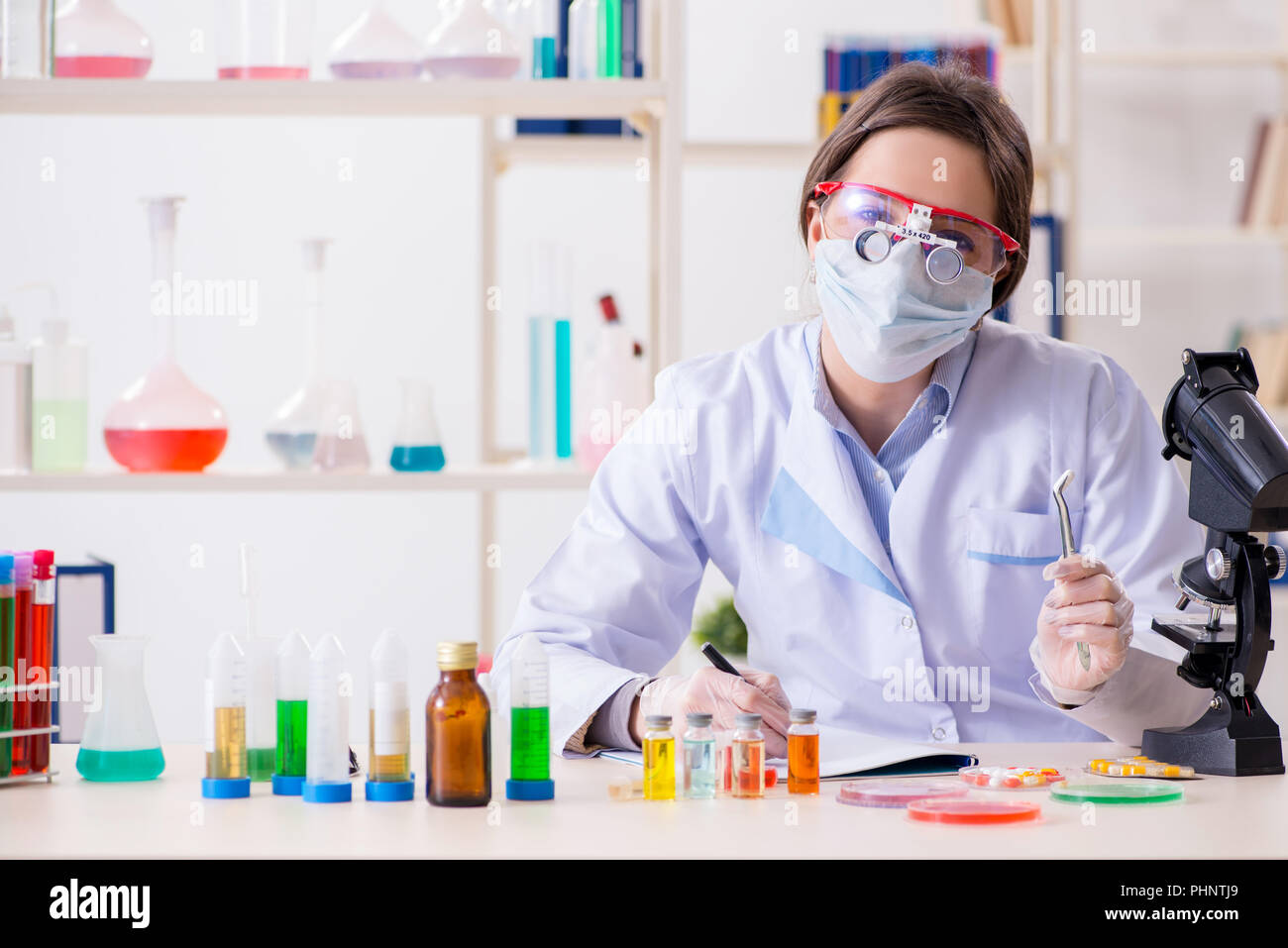 Lab assistant in drug synthesis concept Stock Photo - Alamy