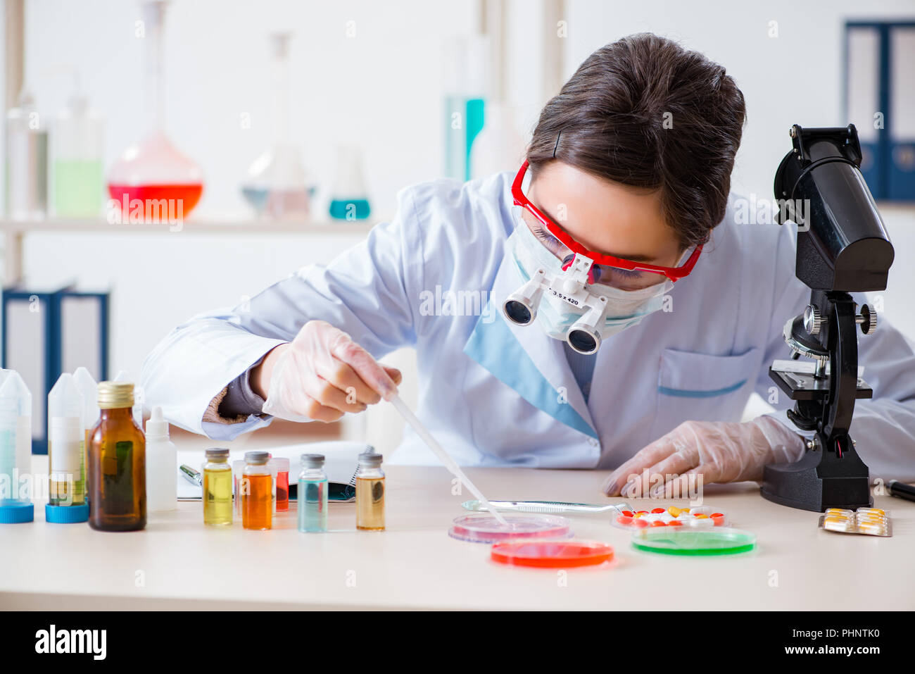 Lab assistant in drug synthesis concept Stock Photo - Alamy
