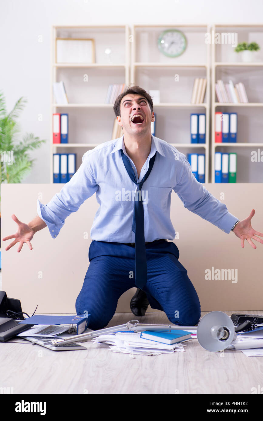 Angry businessman frustrated with too much work Stock Photo - Alamy