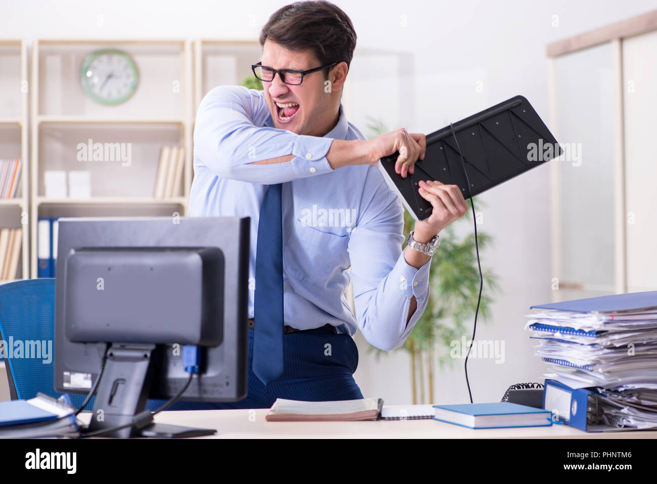 Angry businessman frustrated with too much work Stock Photo - Alamy