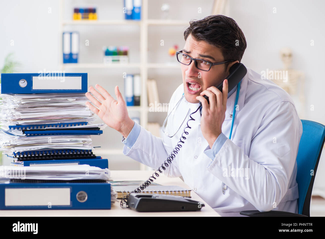 Busy doctor with too much work in hospital Stock Photo - Alamy