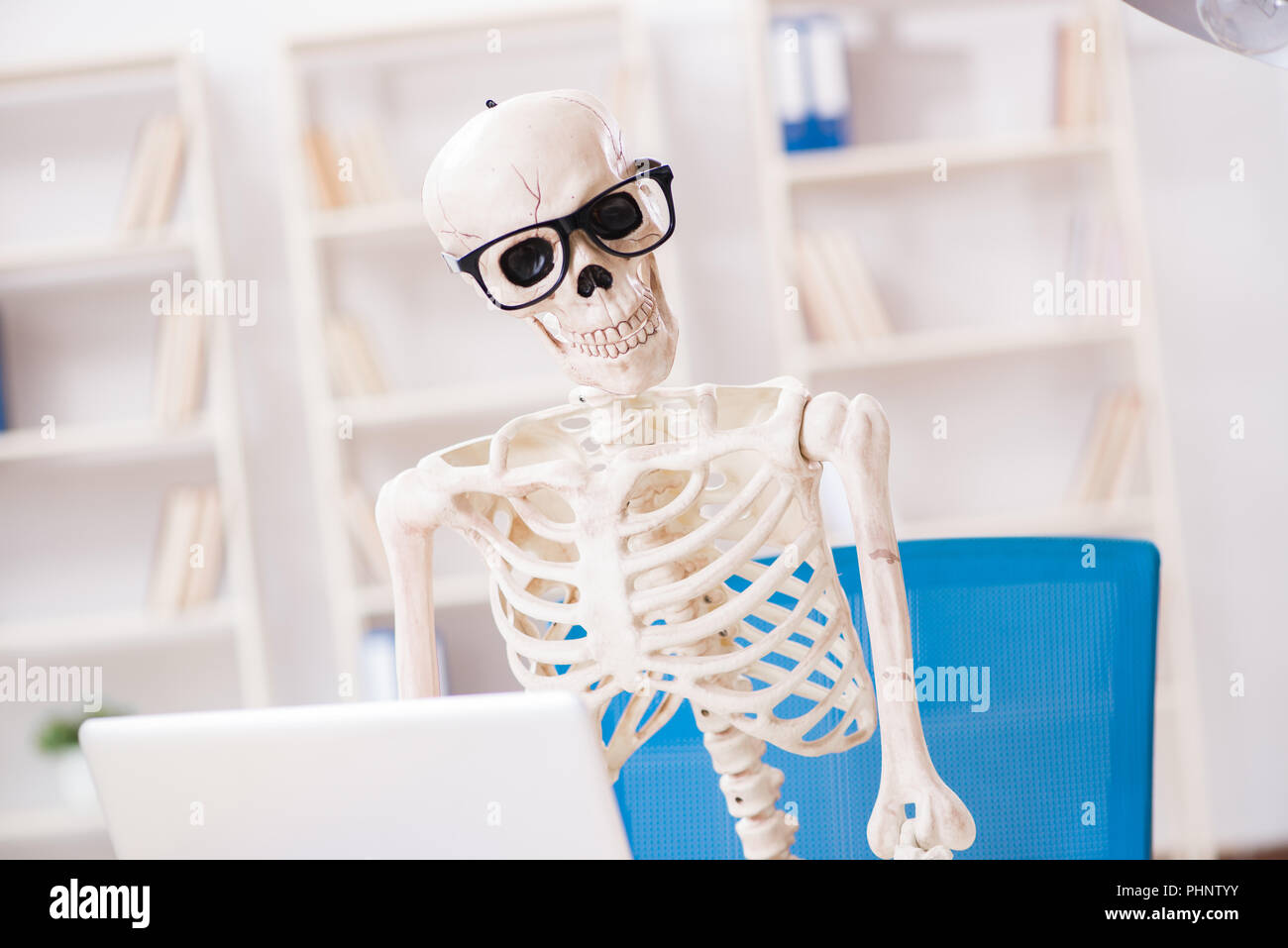 Human skeleton sitting with laptop computer hi-res stock photography ...