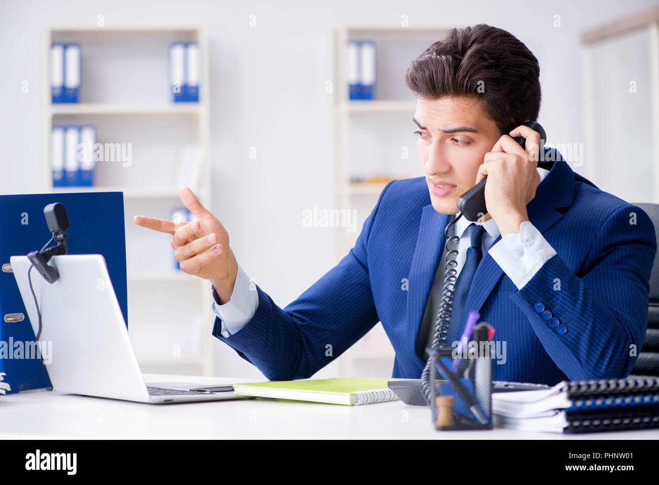 Young help desk operator working in office Stock Photo - Alamy