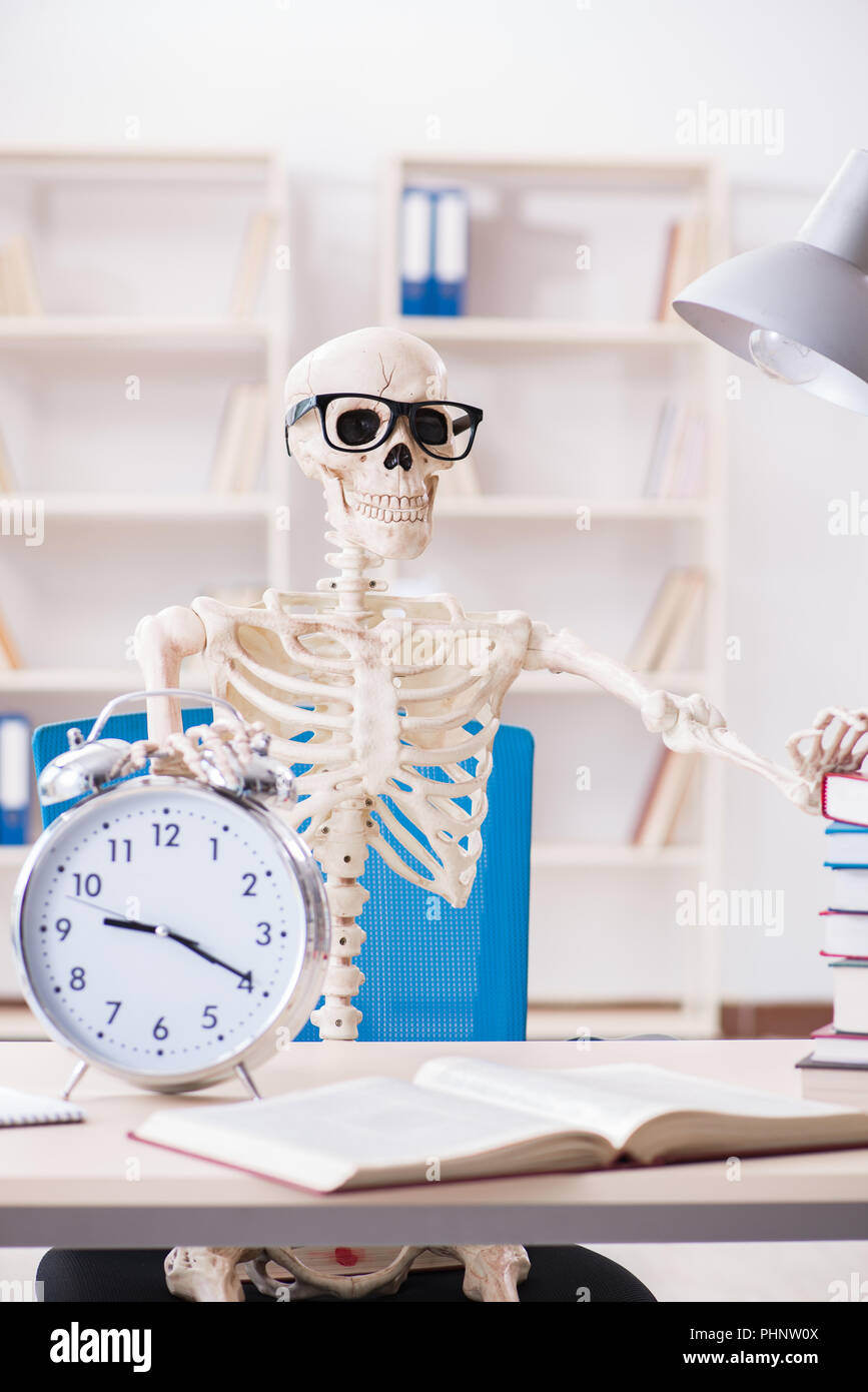 Skeleton businessman working in the office Stock Photo - Alamy
