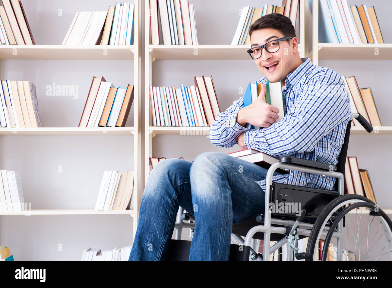 Disabled student studying in the library Stock Photo - Alamy