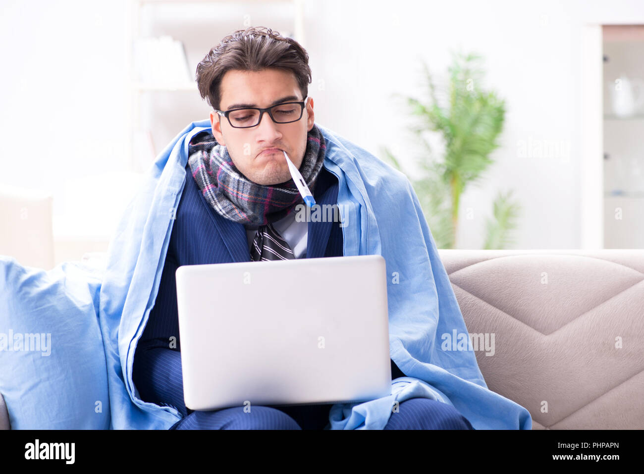 Sick businessman laptop computer temperature hi-res stock photography ...