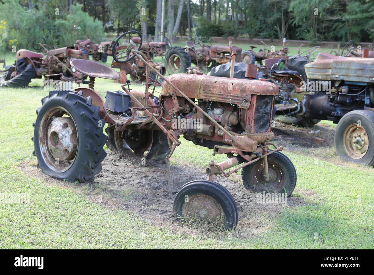 old rusty tractors in junkyard Stock Photo - Alamy