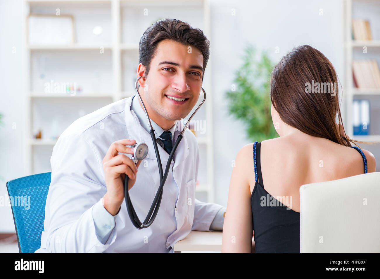 Doctor checking patient with stethoscope Stock Photo - Alamy