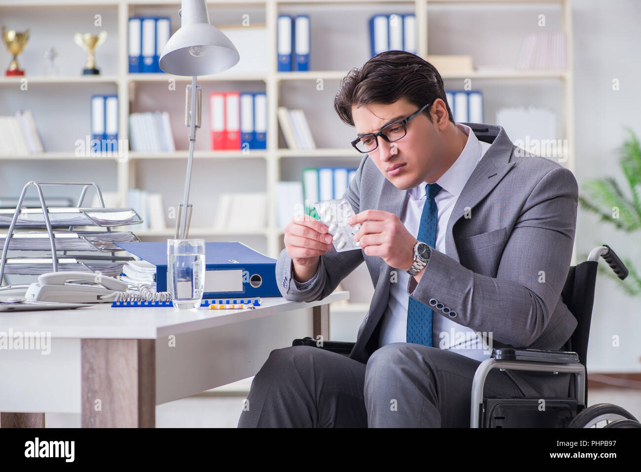 Disabled businessman working in the office Stock Photo - Alamy