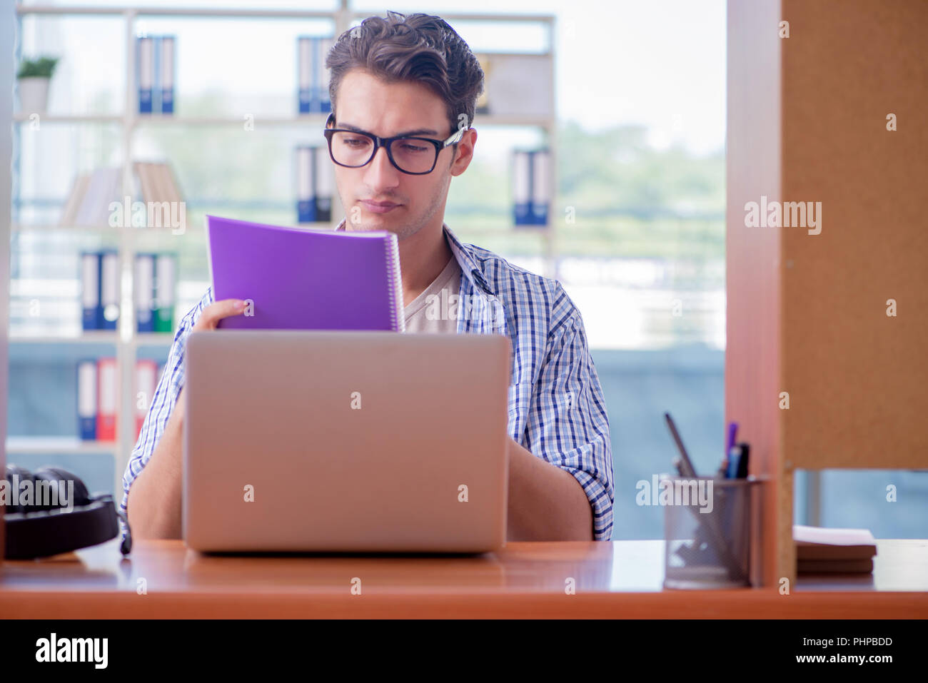Teenager revising laptop books at home hi-res stock photography and ...