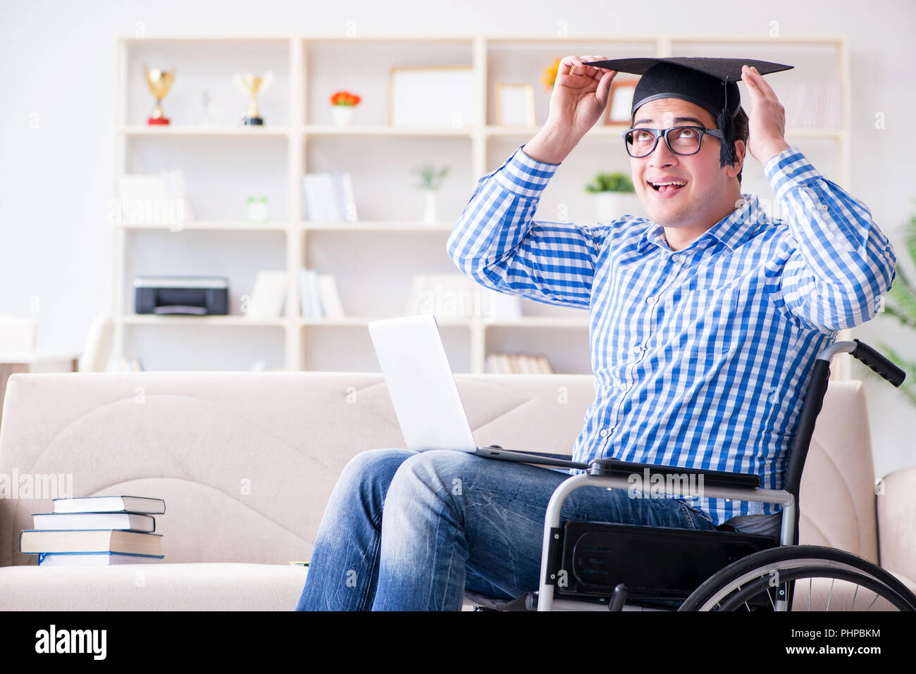 Young student on wheelchair in disability concept Stock Photo - Alamy