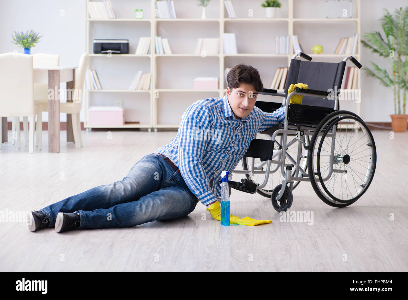 Disabled man on wheelchair cleaning home Stock Photo - Alamy