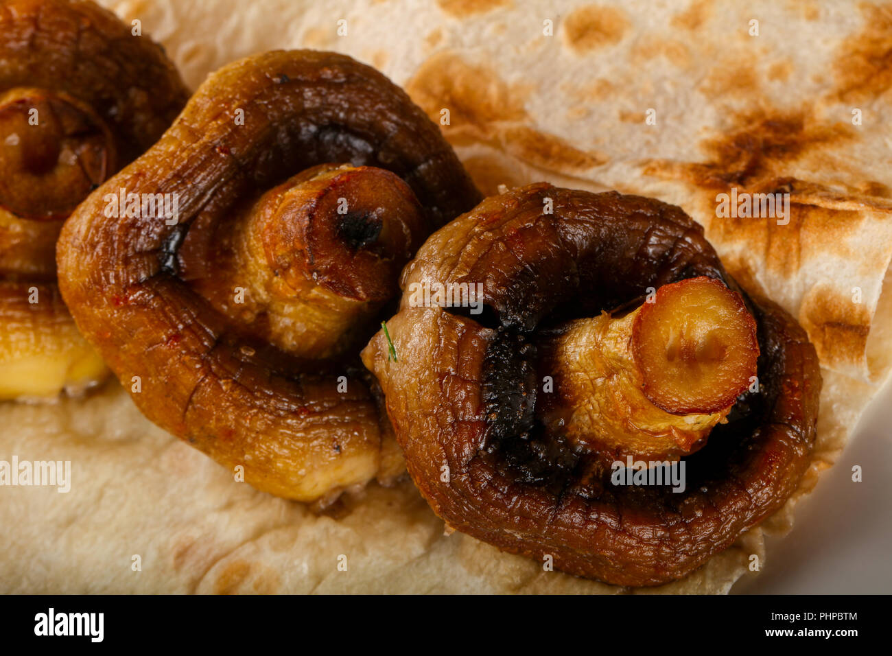 Grilled champignons with bread lavash Stock Photo - Alamy