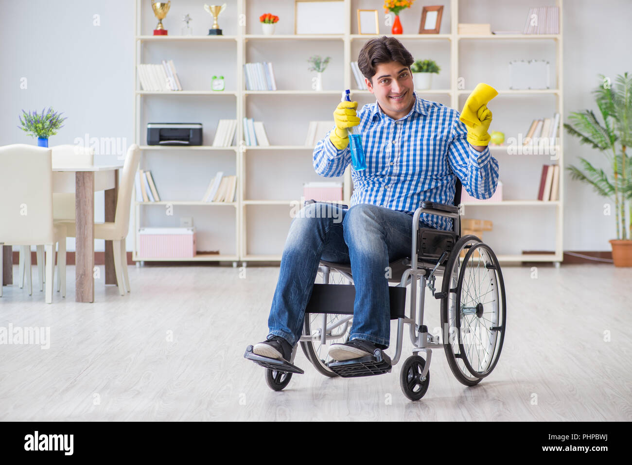 Disabled man on wheelchair cleaning home Stock Photo - Alamy