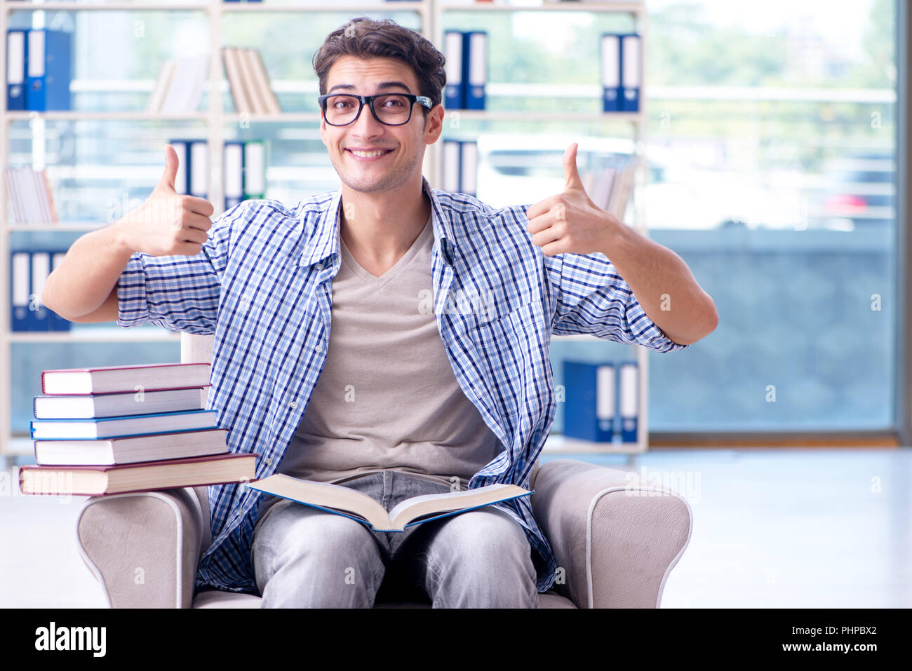 Student reading books and preparing for exams in library Stock Photo ...