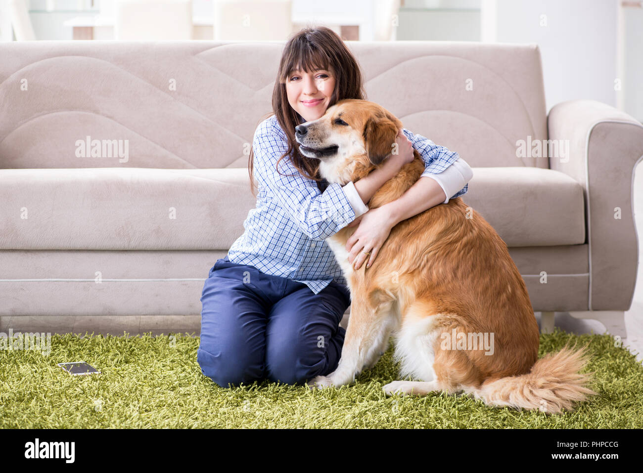 Happy woman dog owner at home with golden retriever Stock Photo - Alamy