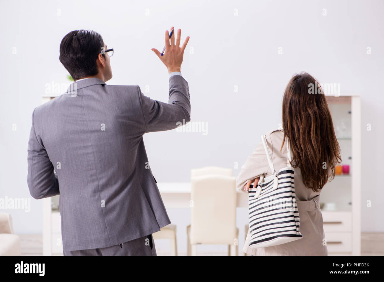 Real estate agent showing new apartment property to client Stock Photo ...