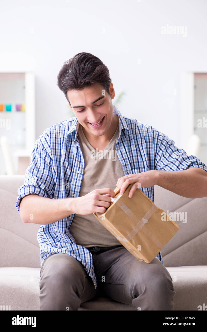 Man receiving parcel at home Stock Photo - Alamy