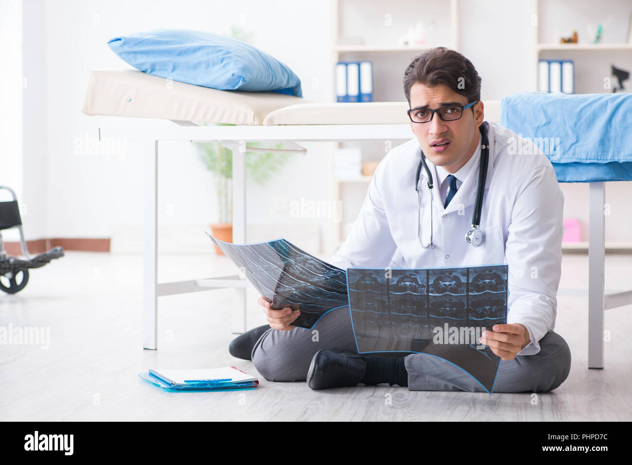 Doctor sitting on the floor in hospital Stock Photo - Alamy