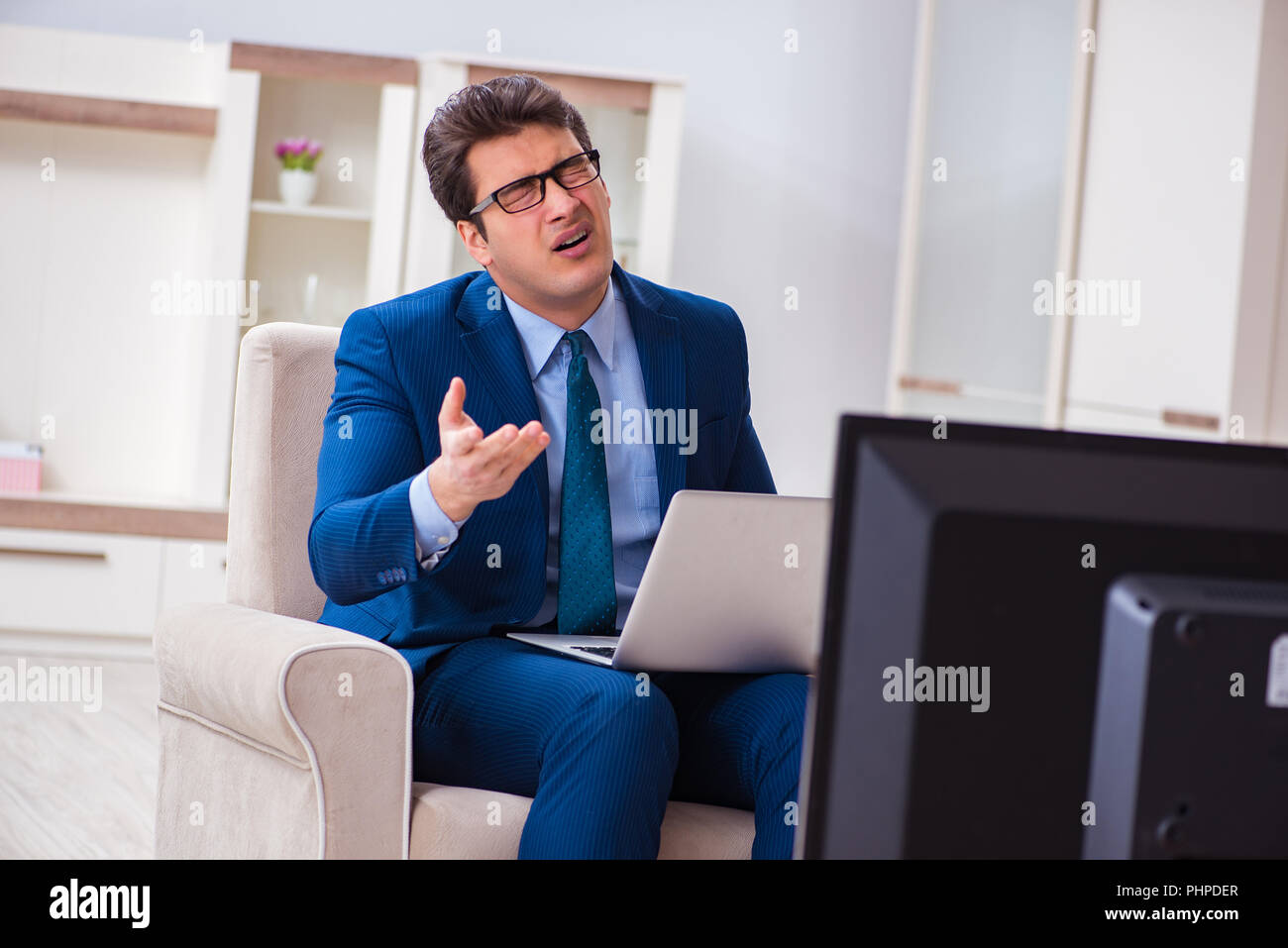 Businesman watching tv in office Stock Photo - Alamy