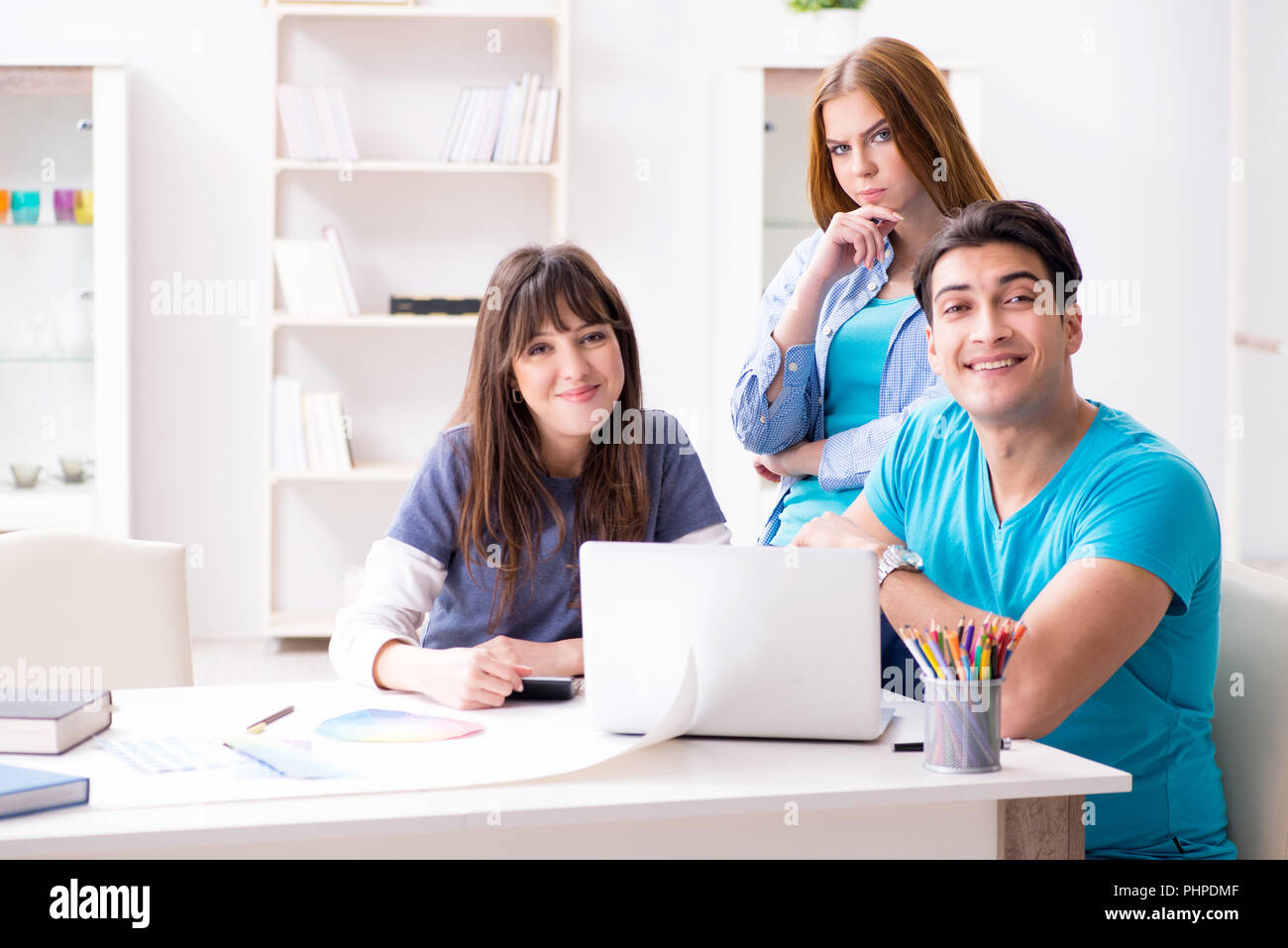 Team of designers discussing new interior project Stock Photo - Alamy